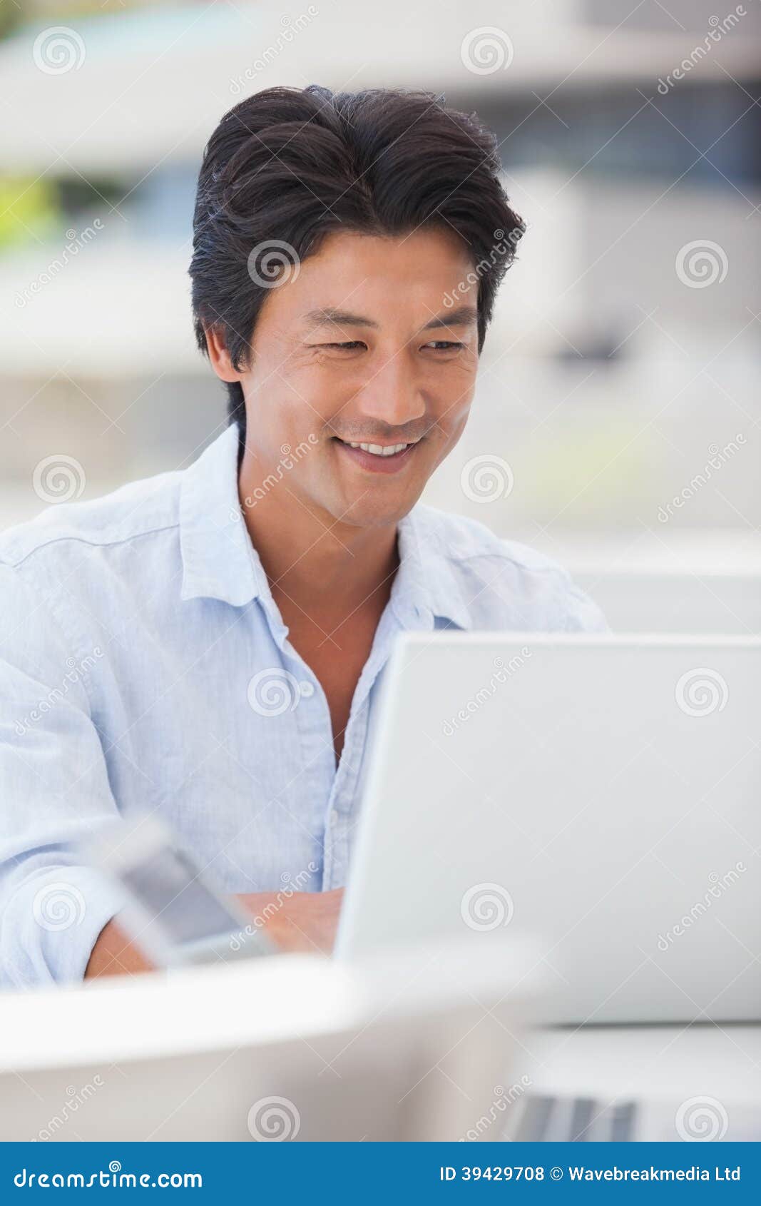 Happy man using his laptop stock photo. Image of household - 39429708