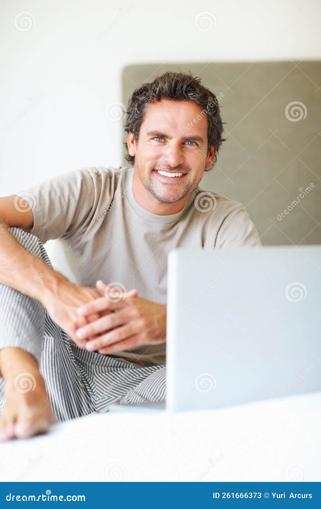 Happy Man Using Laptop In Bed Portrait Of Handsome Man Sitting With