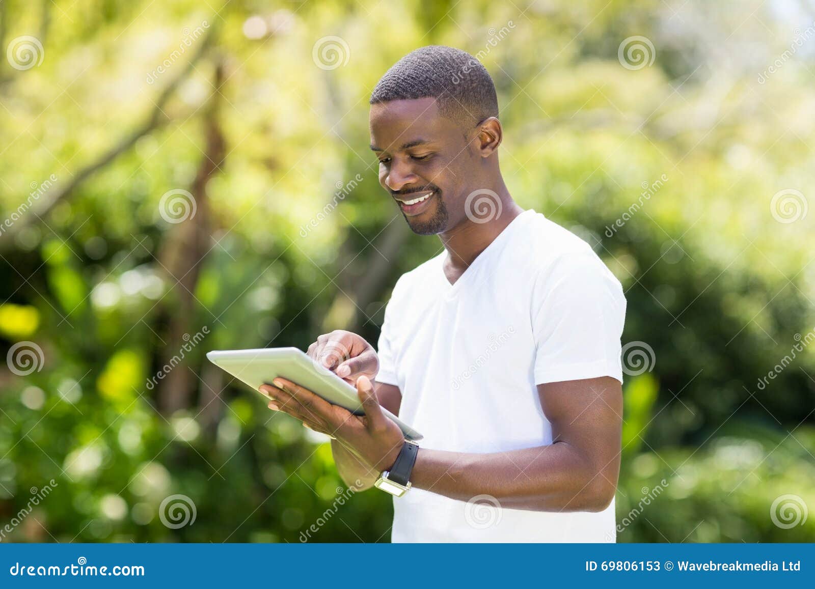 Happy man using a tablet stock image. Image of showing - 69806153