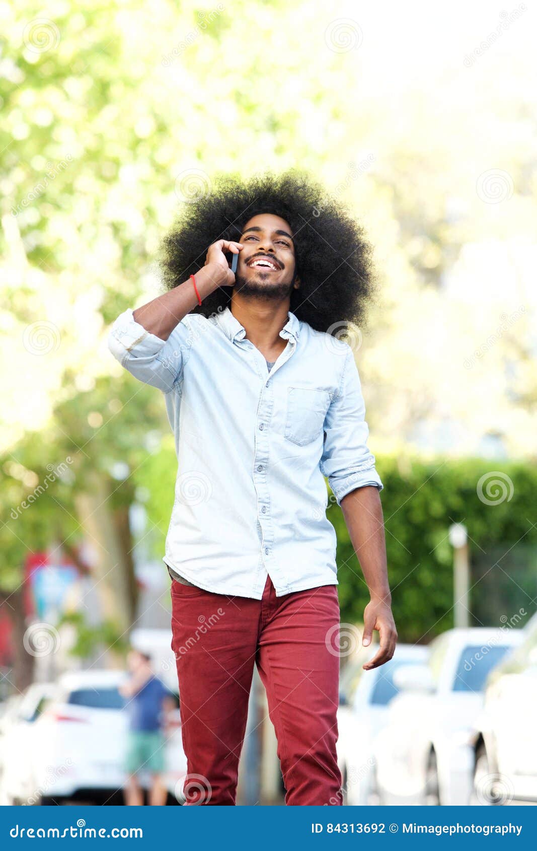 Happy Man Walking and Talking Outside with Mobile Phone Stock Photo ...