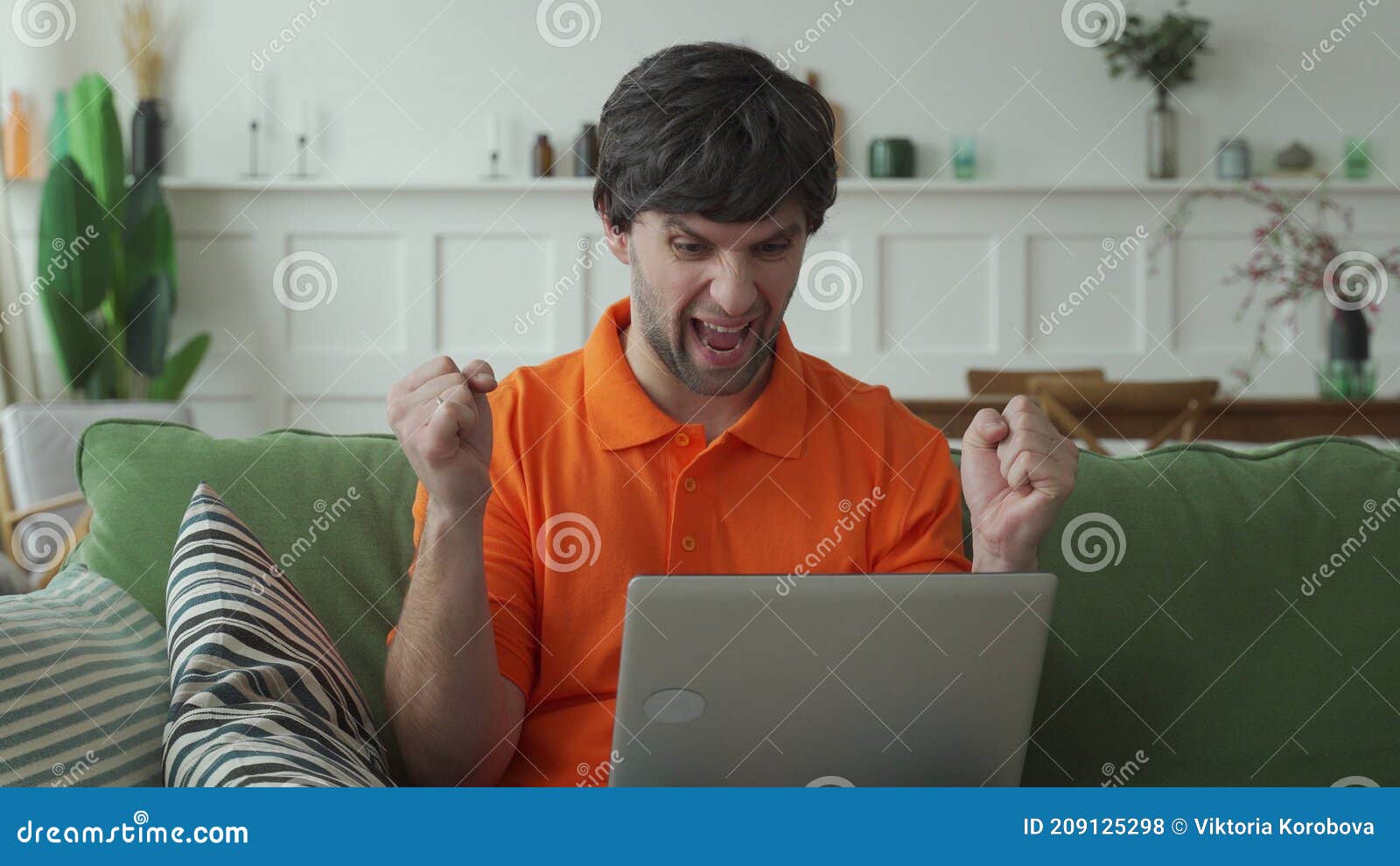 Happy Man Working at Computer at Home and Celebrating Victory with ...