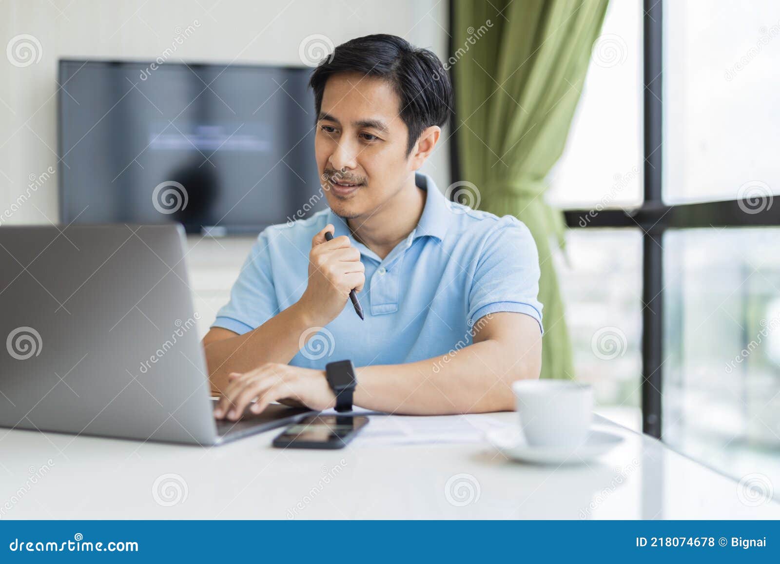 Happy Man Working Online with Laptop Computer at Home Sitting at Desk ...