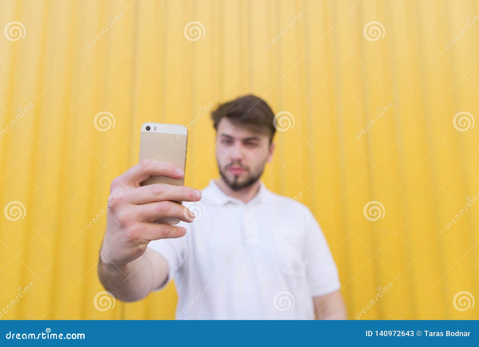 Happy Man on a Yellow Background Makes for Selfie Smartphone in Hand ...