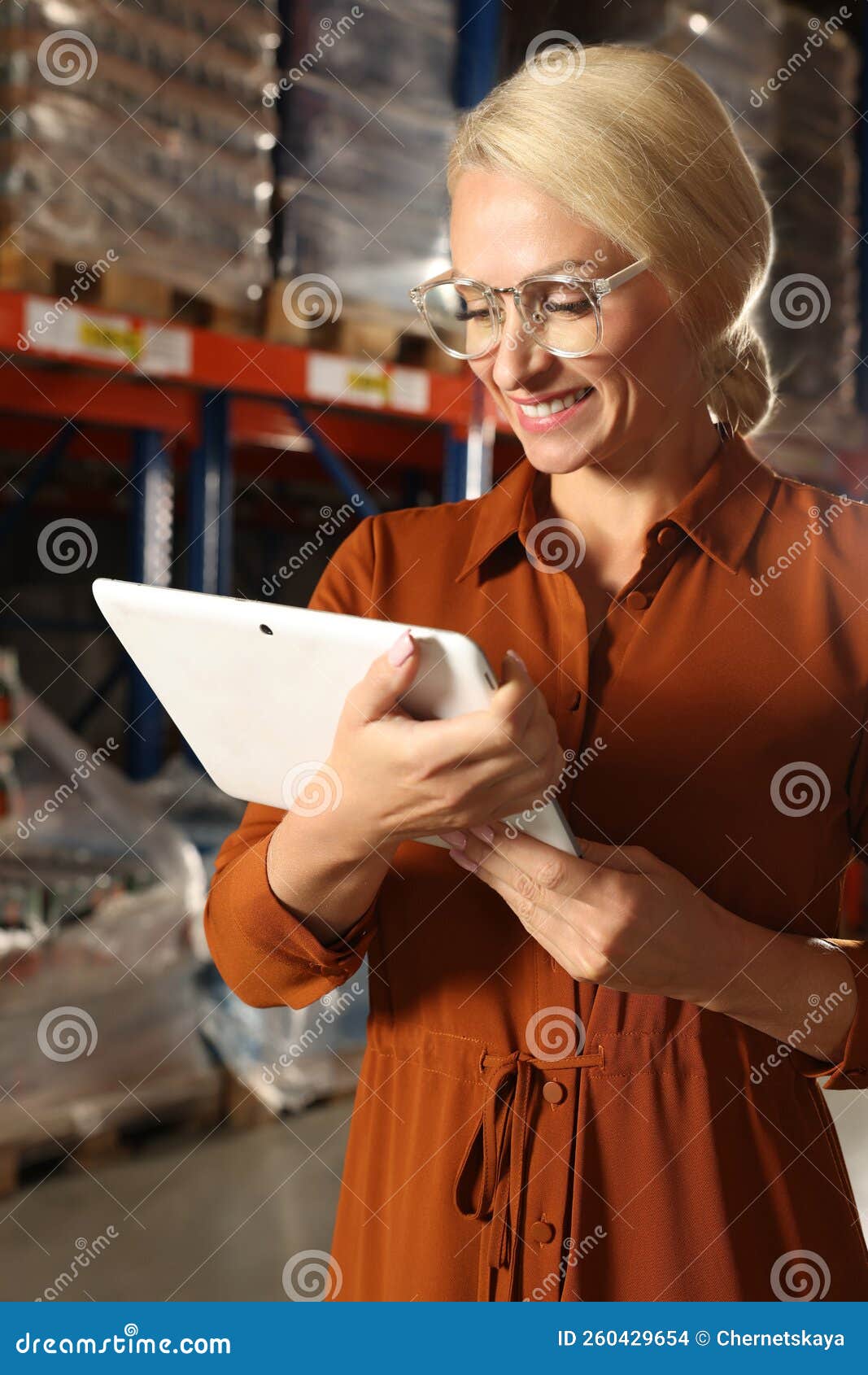 Happy Manager Using Modern Tablet in Warehouse with Lots of Products ...