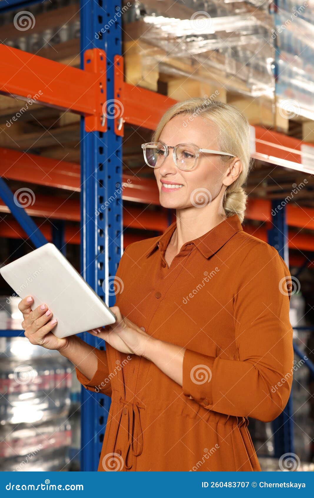 Happy Manager Using Modern Tablet in Warehouse with Lots of Products ...