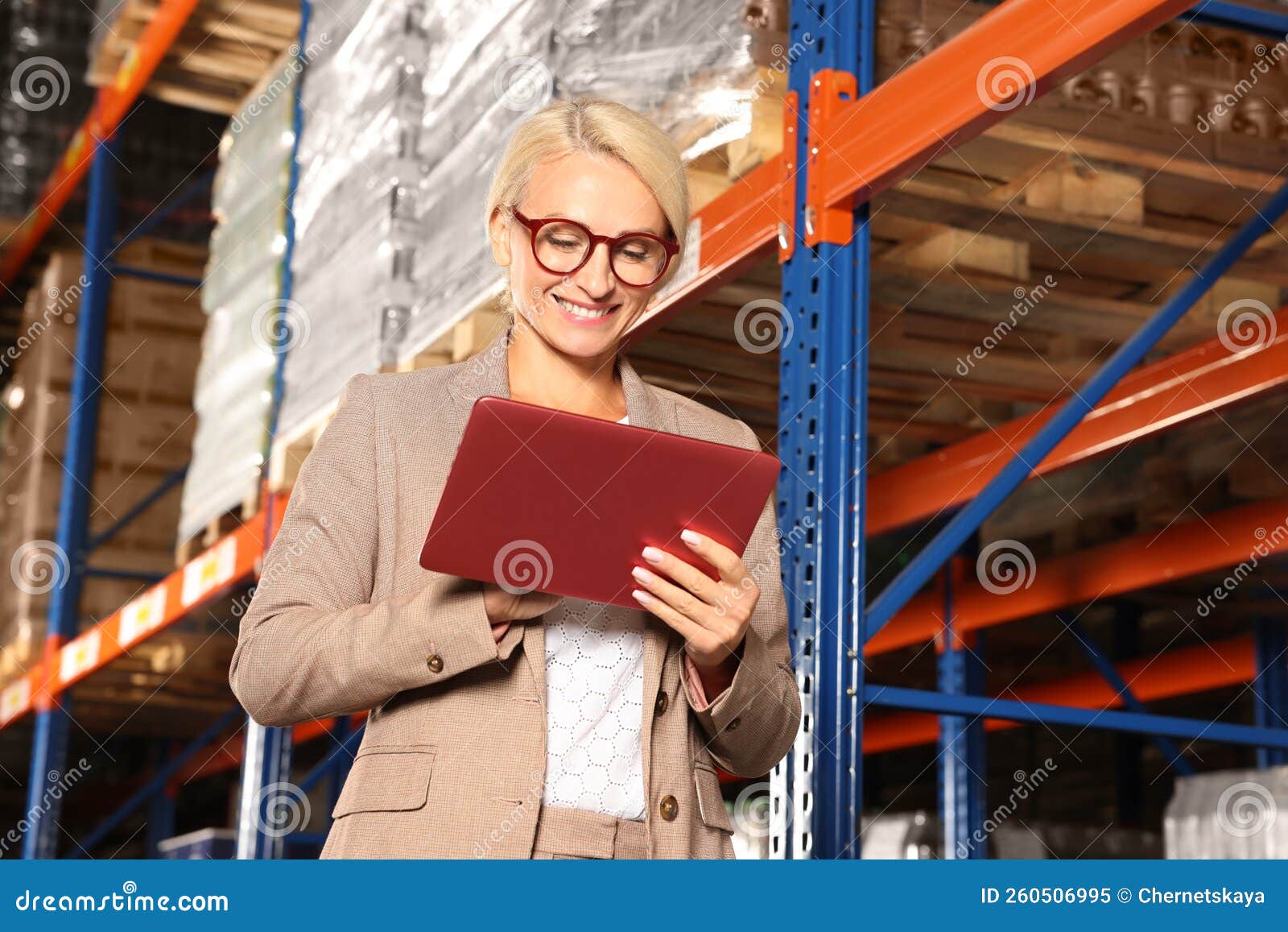 Happy Manager Using Modern Tablet in Warehouse with Lots of Products ...