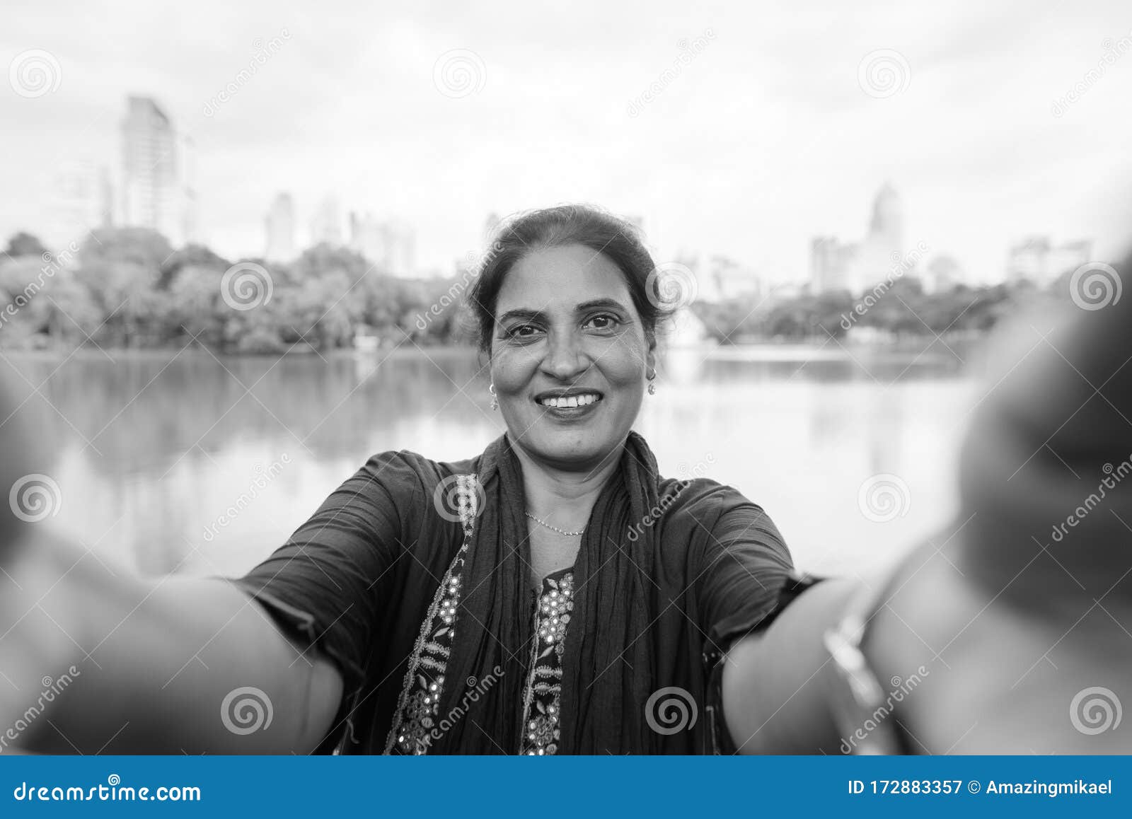 Happy Mature Beautiful Indian Woman Taking Selfie At The Park Stock