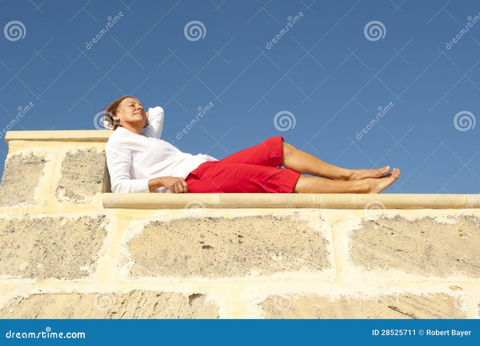 Happy Mature Woman Lying on Wall Stock Image - Image of isolated ...