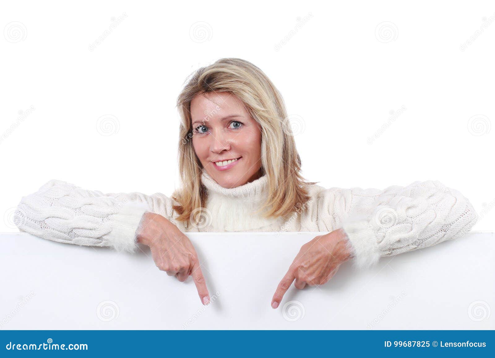 Happy Mature Woman Points Down on a White Wall Stock Image - Image of ...