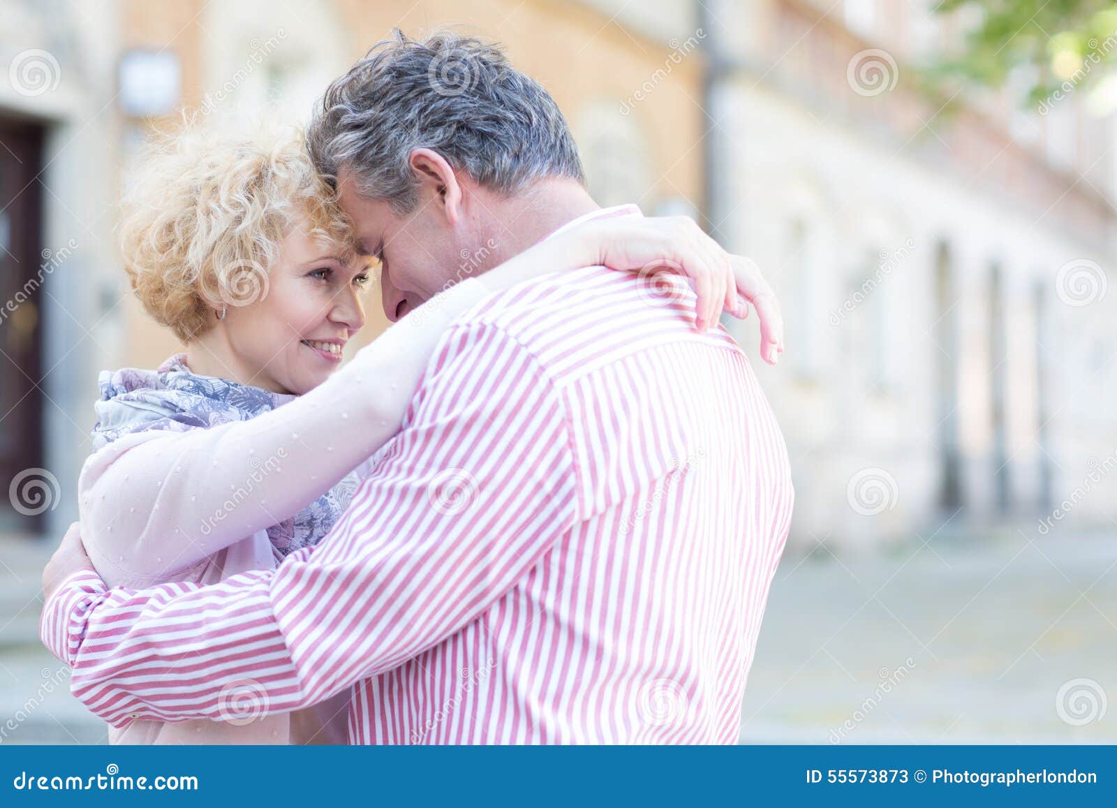 Happy Middle-aged Couple Embracing in City Stock Image - Image of ...
