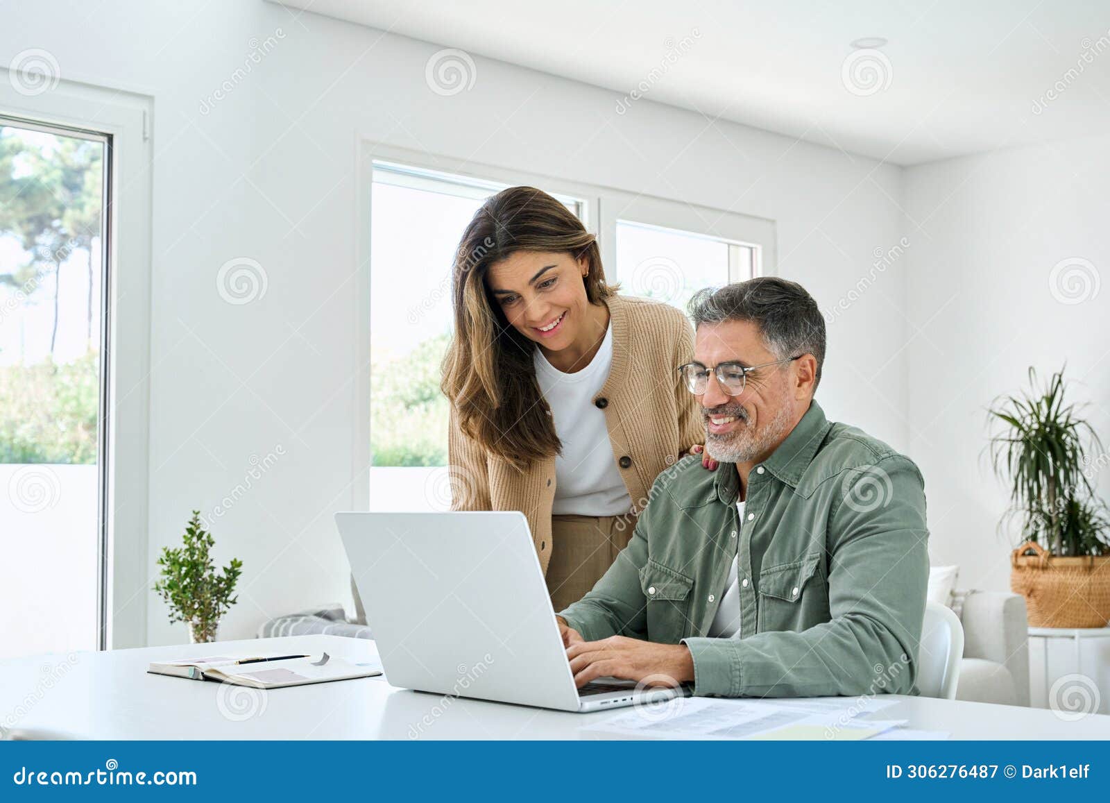 Happy Middle Aged Couple Using Laptop Technology at Home. Authentic ...