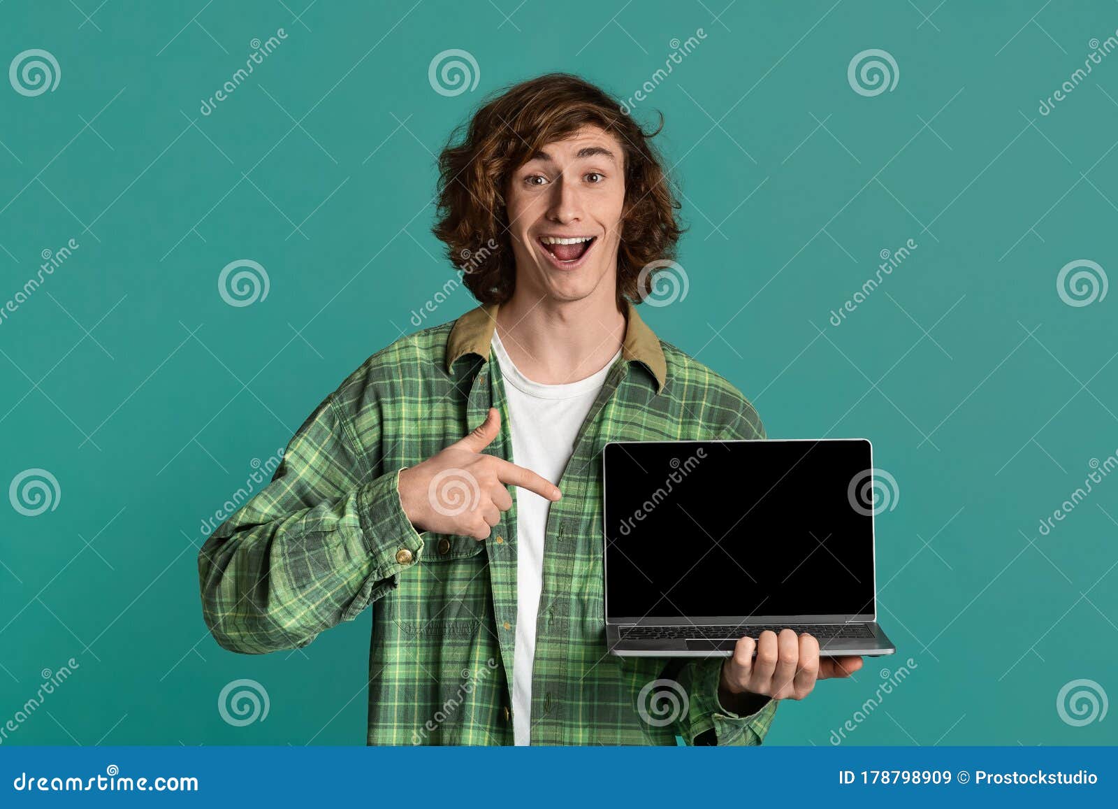 Happy Millennial Guy Pointing at Laptop Computer with Empty Screen on ...