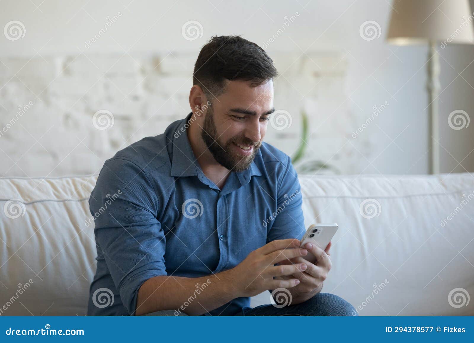 Happy Millennial Smartphone User Man Sitting on Couch at Home Stock ...