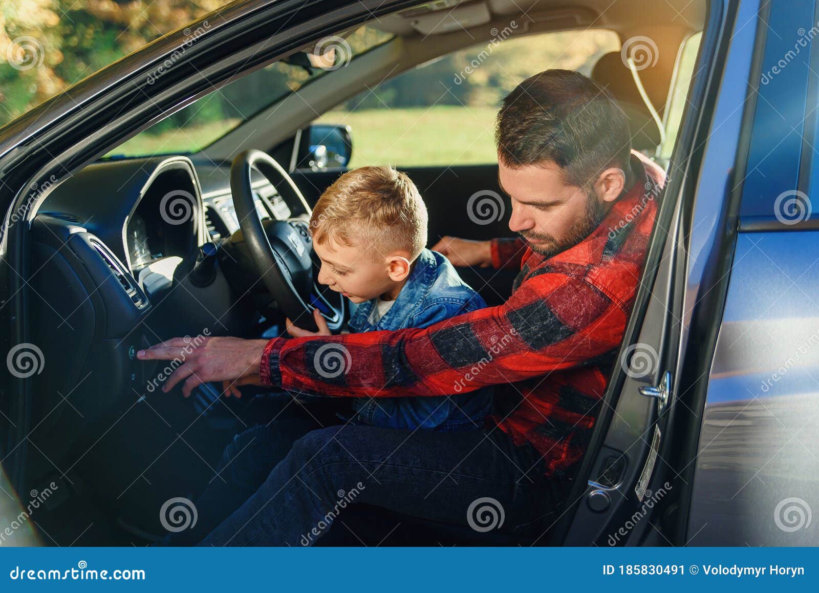 Father Gives His Son Driving Lessons Enjoying Time Together Stock