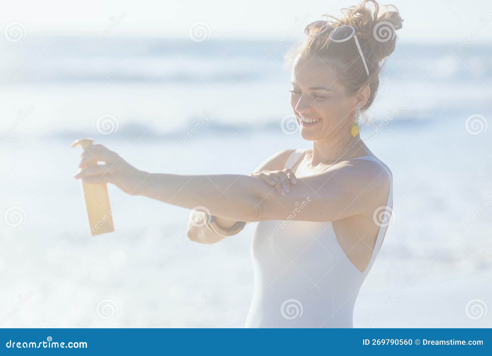Happy Modern Woman in White Swimsuit at Beach Using Spf Stock Photo ...