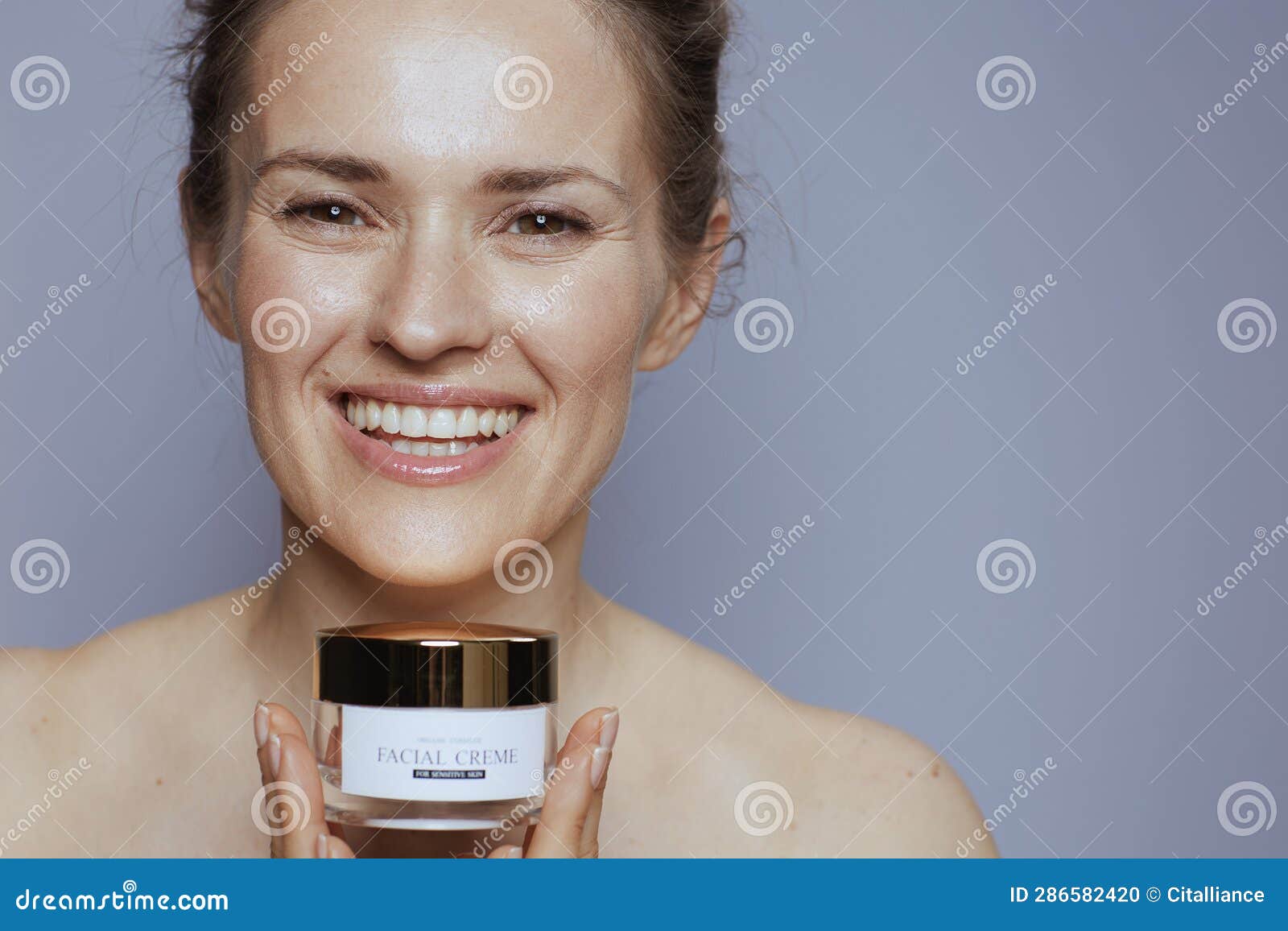 Happy Modern 40 Years Old Woman With Cosmetic Cream Jar Stock