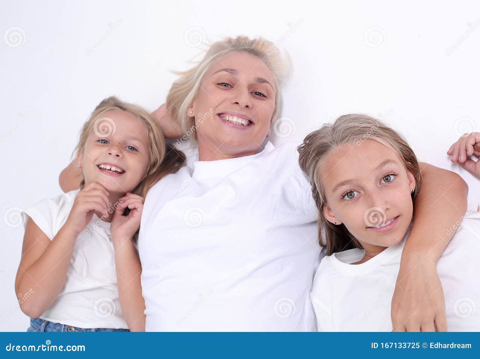 Happy Mom With Her Two Daughters Looking At The Camera Stock Image