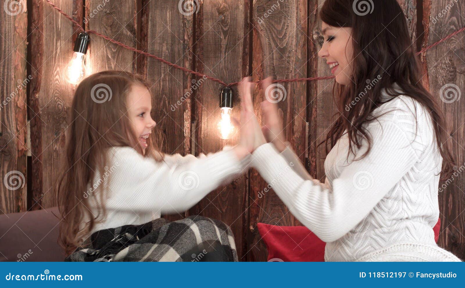 Happy Mother and Daughter Playing Clapping Game on Christmas Eve Stock ... Happy Mother and Daughter Playing Clapping Game on Christmas Eve Stock ...