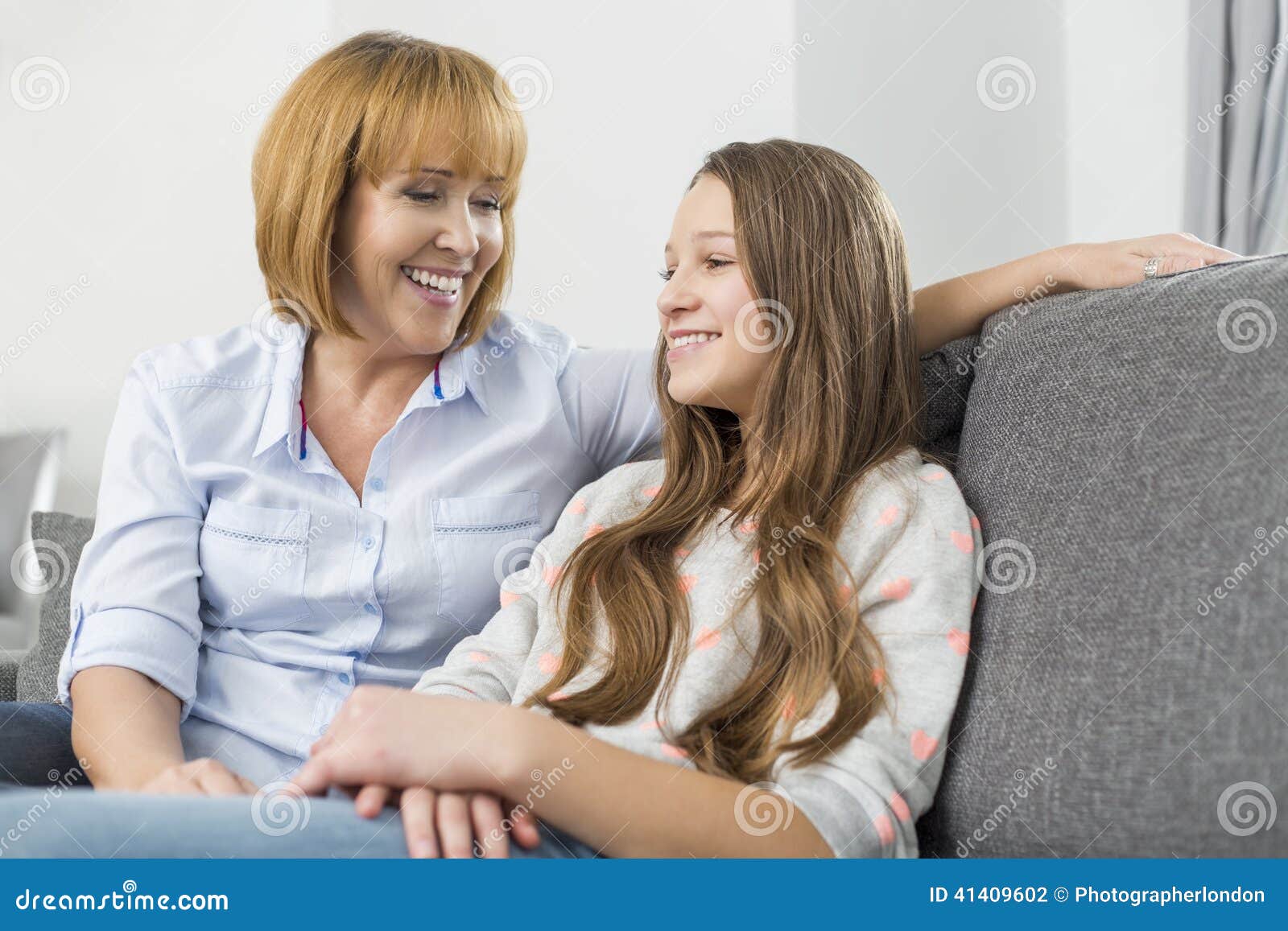 Happy Mother and Daughter Relaxing on Sofa at Home Stock Photo - Image ...