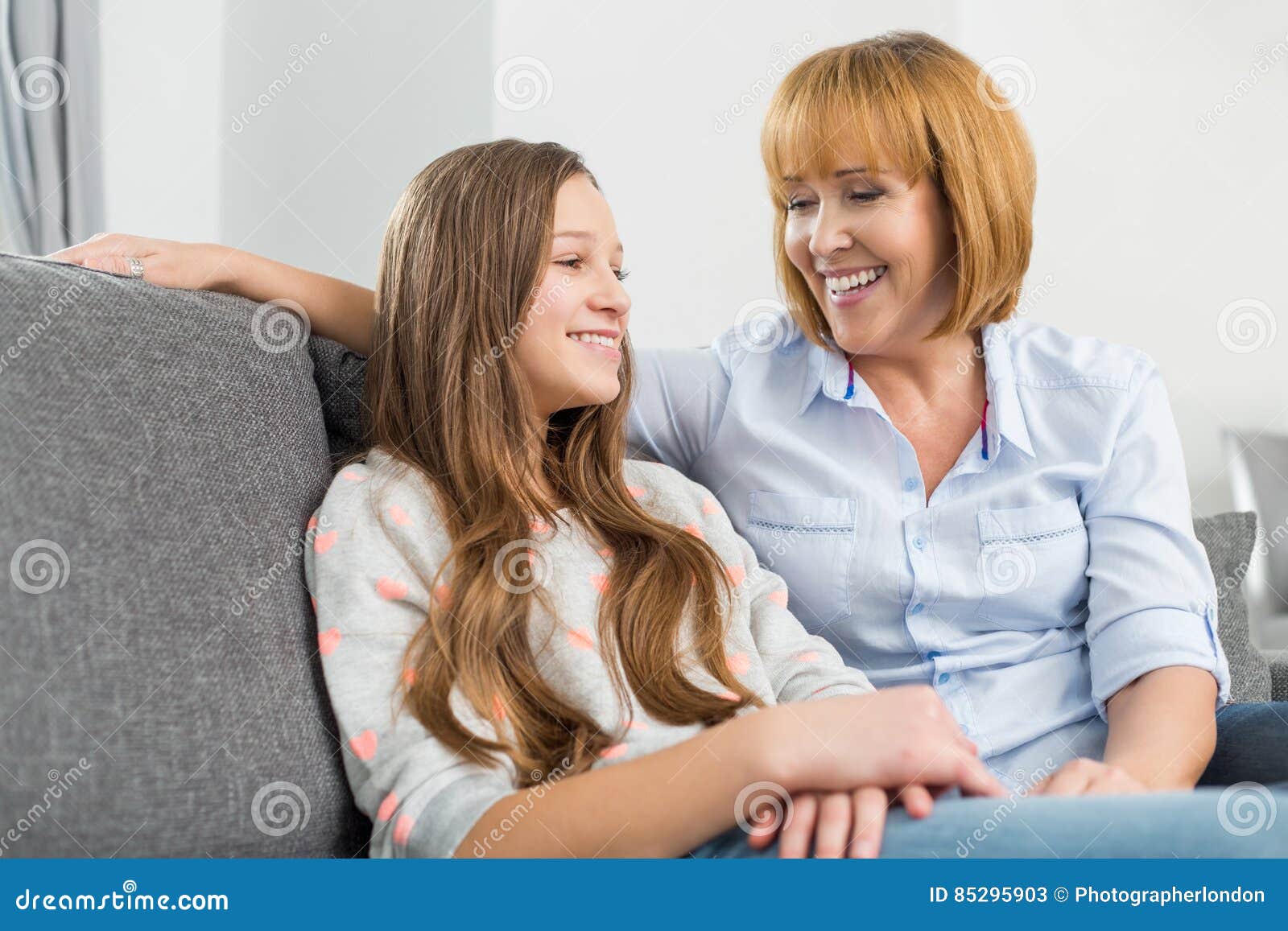 Happy Mother And Daughter Relaxing On Sofa At Home Stock Image Image