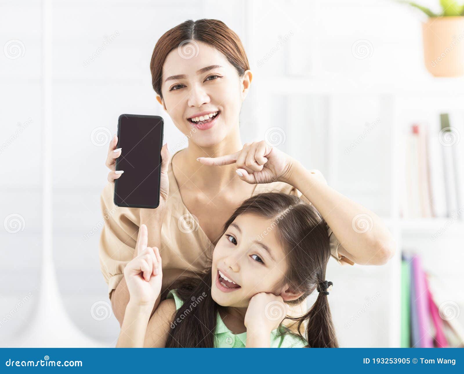 Happy Mother and Daughter Showing the Mobile Phone Stock Image - Image ...