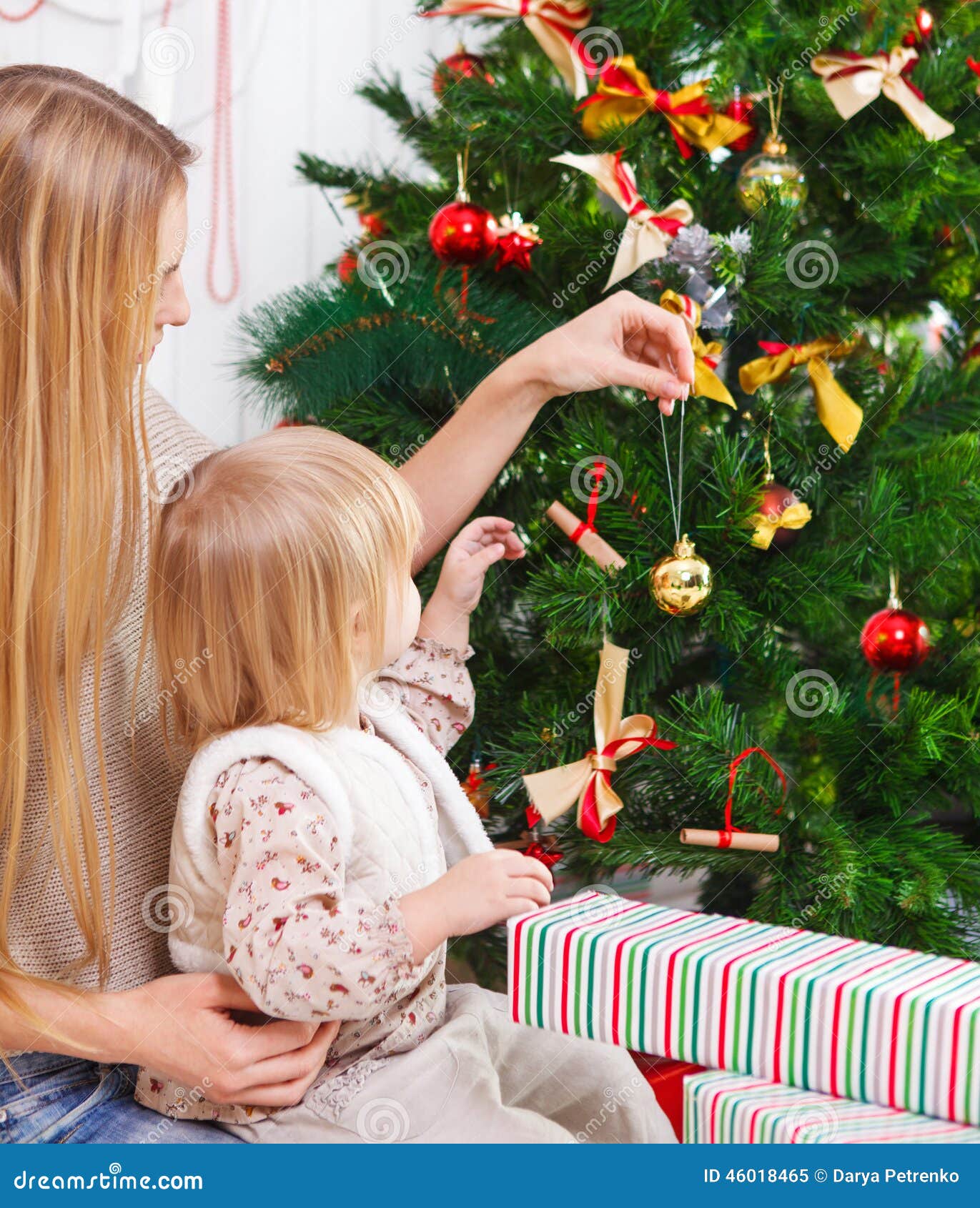Happy Mother And Her Daughter Decorating A Christmas Tree Stock Image