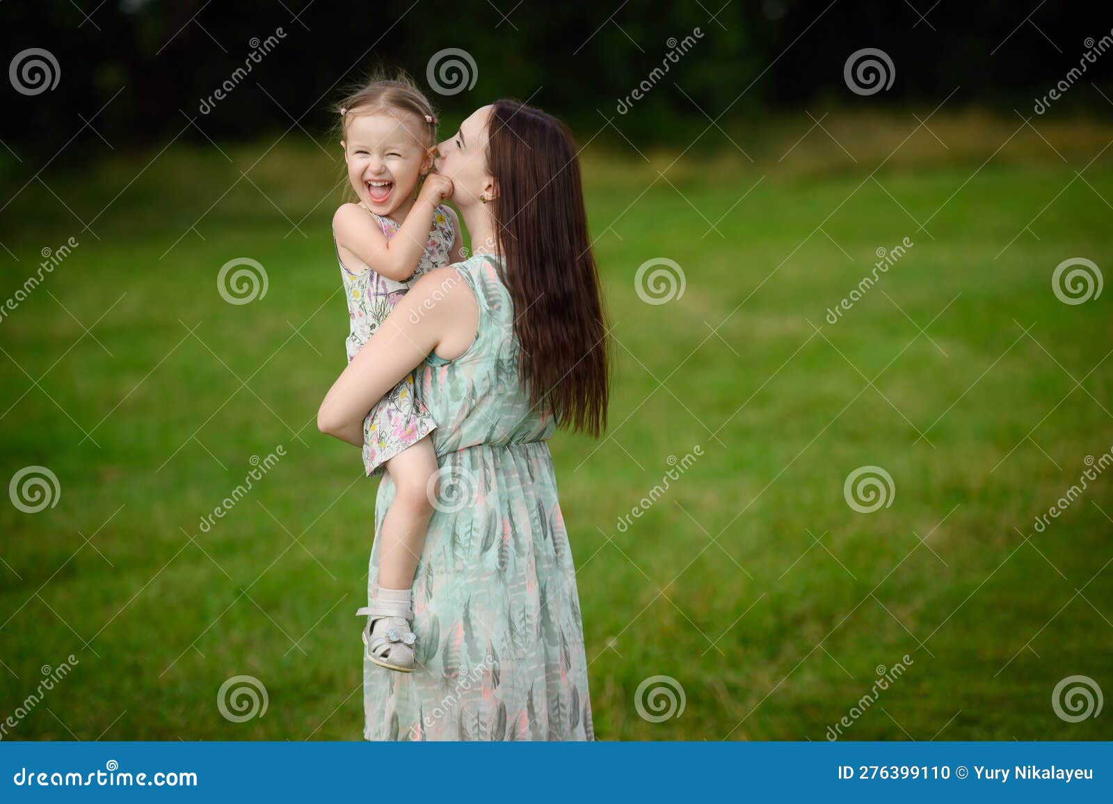 Happy Mother Holding Her Daughter In Her Arms Hugging Spending Time