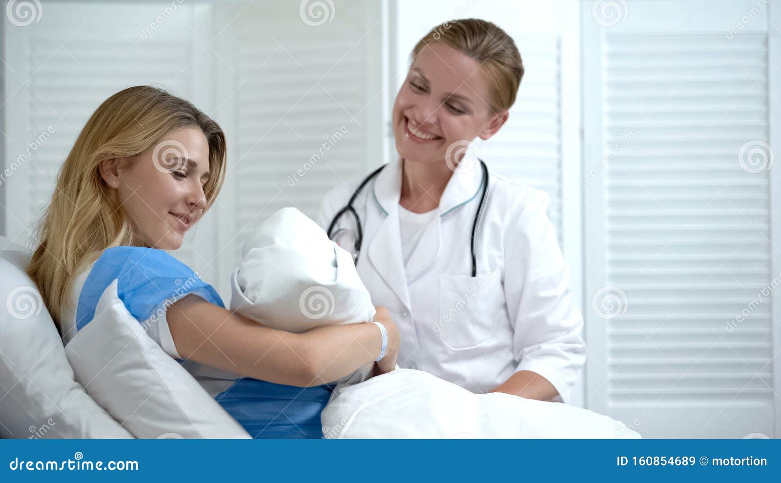 Happy Mother Holding Newborn Baby, Smiling Doctor Looking at Child ... Happy Mother Holding Newborn Baby, Smiling Doctor Looking at Child ...