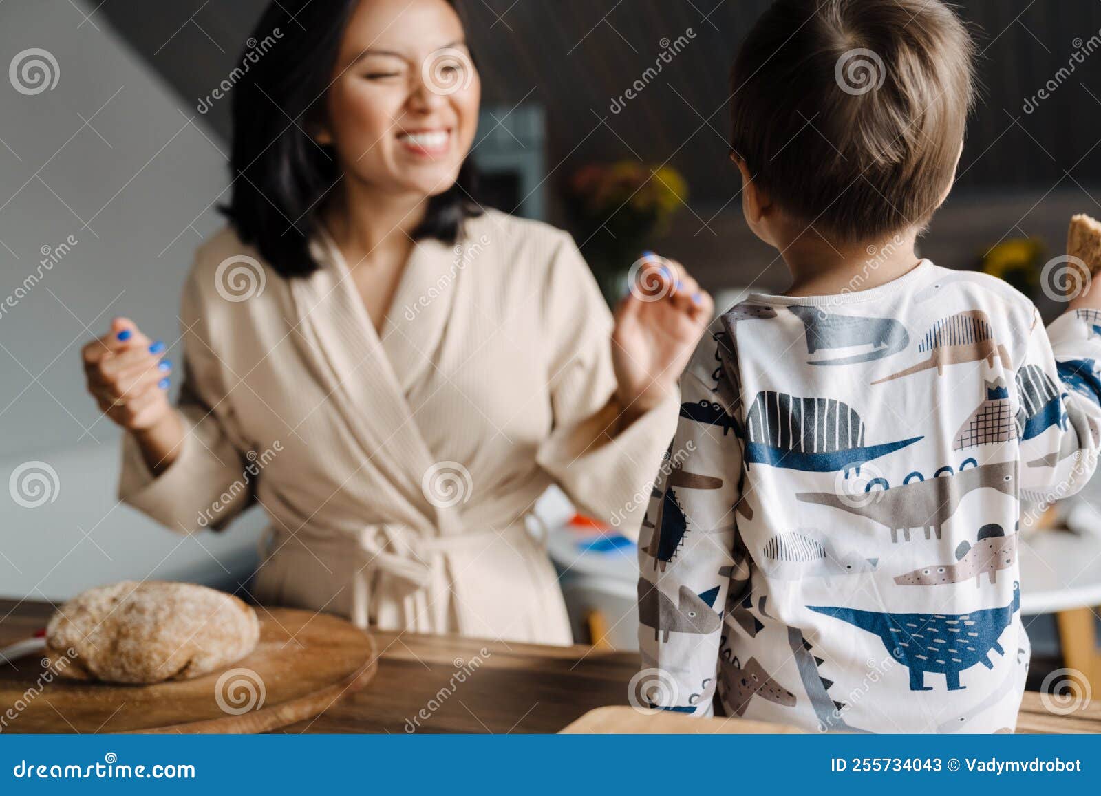 Happy Mother Making Fun with Her Son while Cutting Bread Stock Image ...