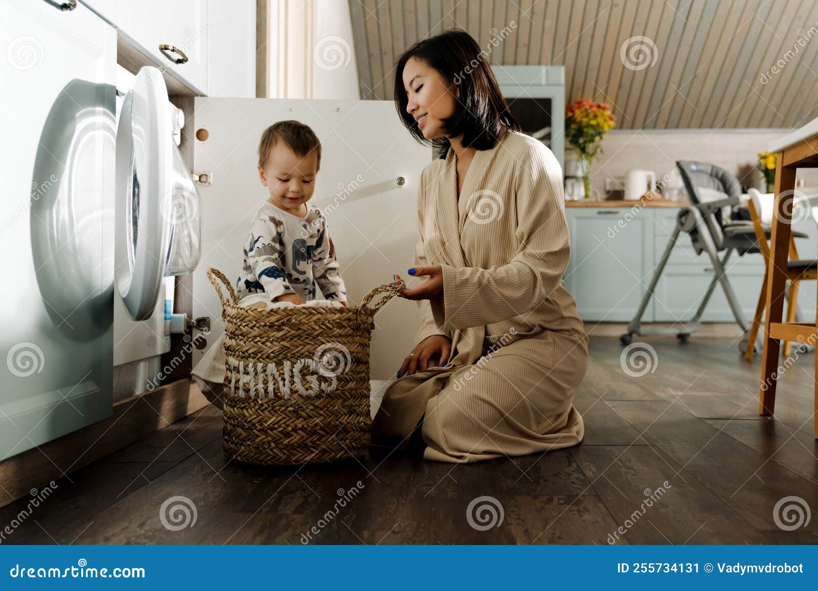 Happy Mother Smiling while Doing Housework with Her Son with Her Son ...