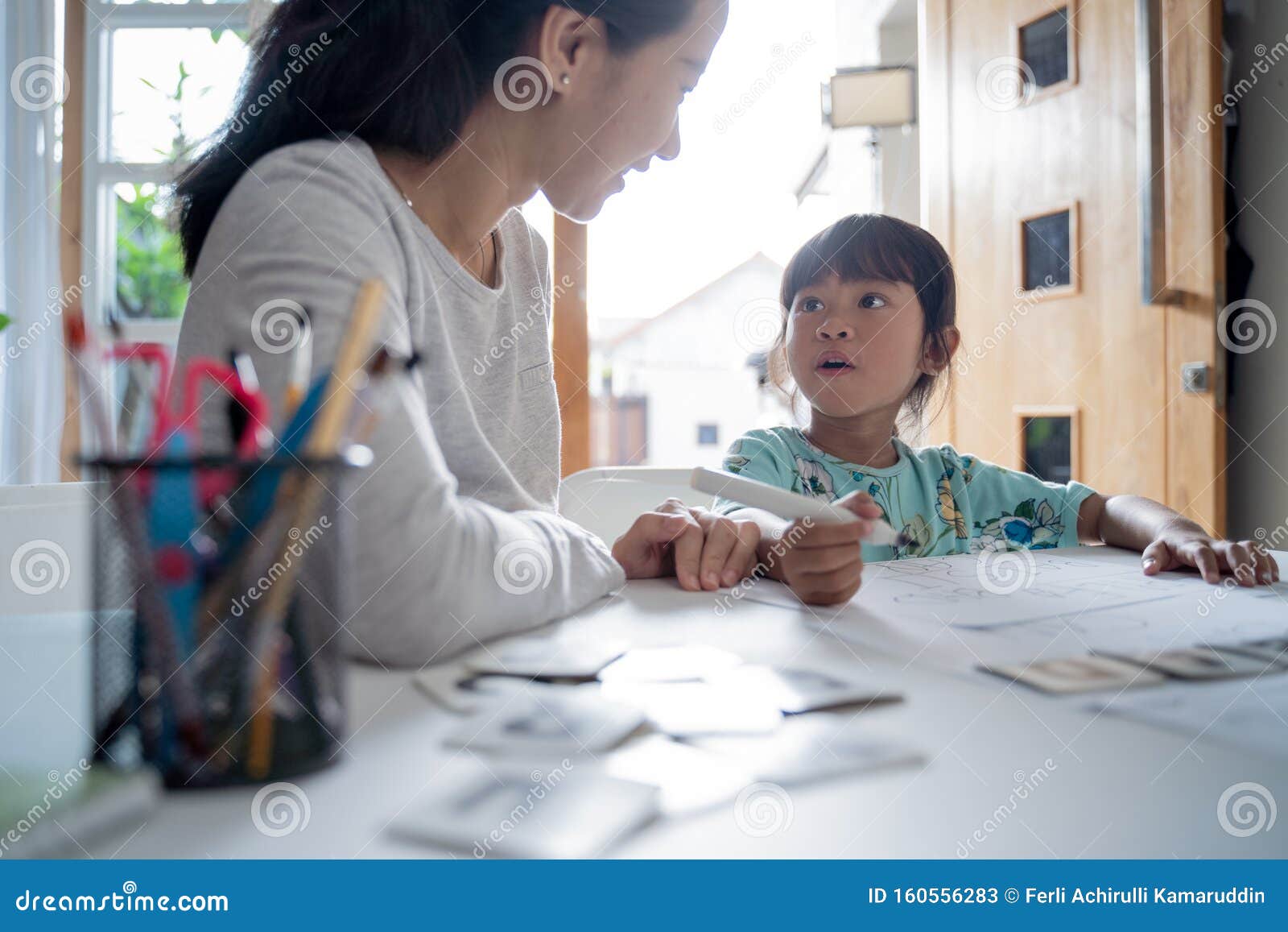 Mother Teaching Her Daughter the Basic To Read and Write Stock Image ...