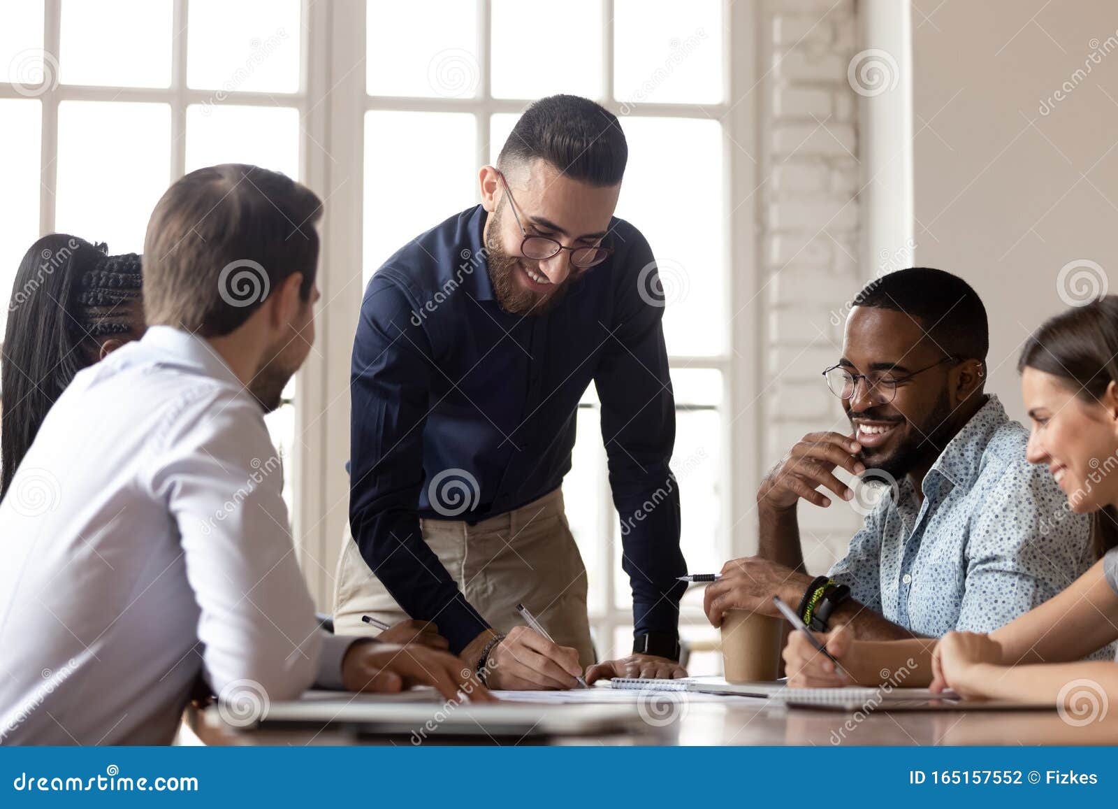 Happy Motivated Arabic Manager Editing Contract or Writing Down Notes ...