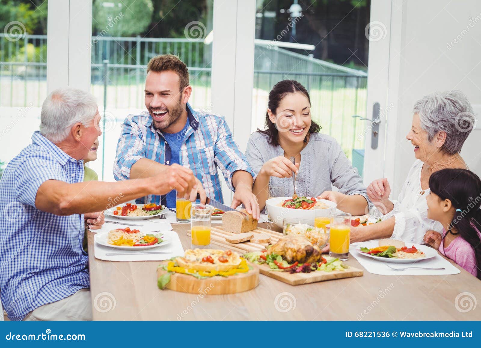 Happy Multi Generation Family Having Food at Dining Table Stock Photo ...