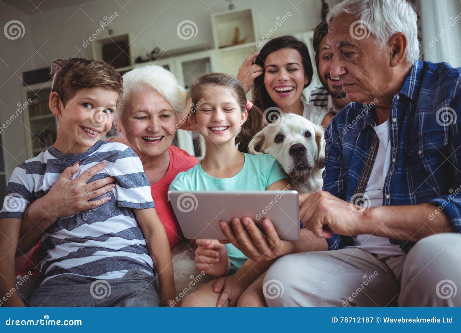 Happy Multi-generation Family Using Digital Tablet in Living Room Stock ...