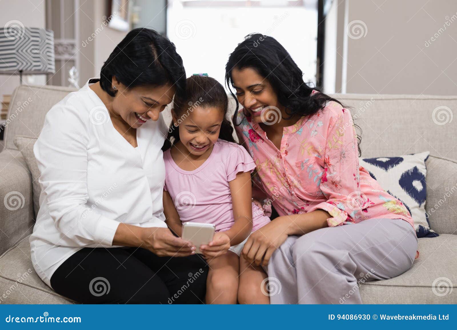Happy Multi-generation Family Using Mobile Phone Together at Home Stock ...