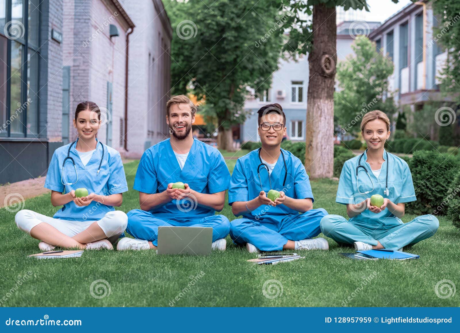Happy Multicultural Medical Students Sitting on Grass Stock Image ...