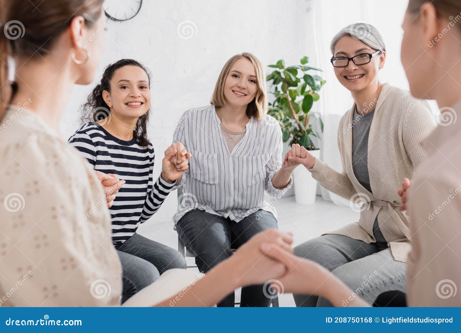 Happy Multicultural Women Holding Hands during Stock Photo - Image of ...