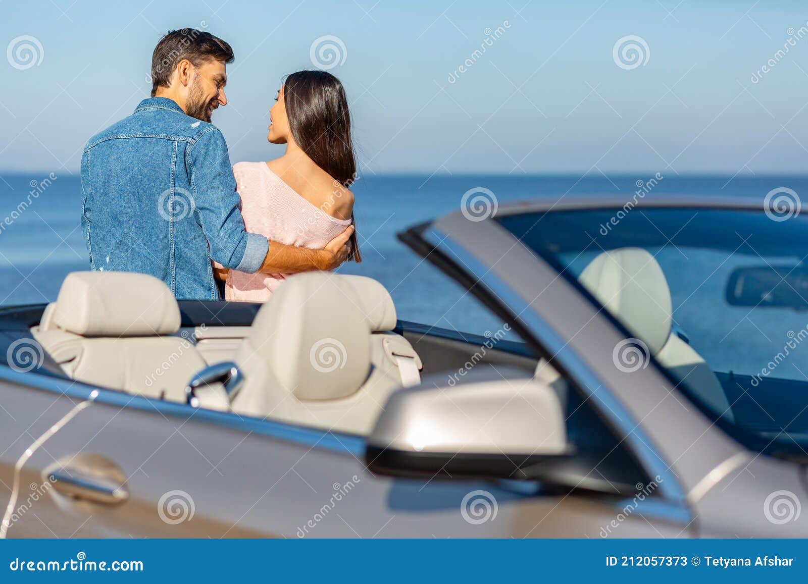 Happy Multiethnic Couple Hugging Together with Car on Foreground Stock ...