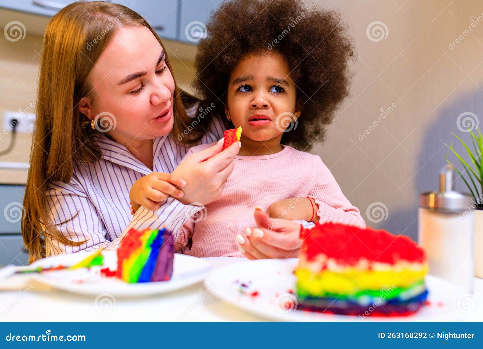 Happy Multiethnic Family Eating Rainbow Cake at Kitchen Stock Photo ...