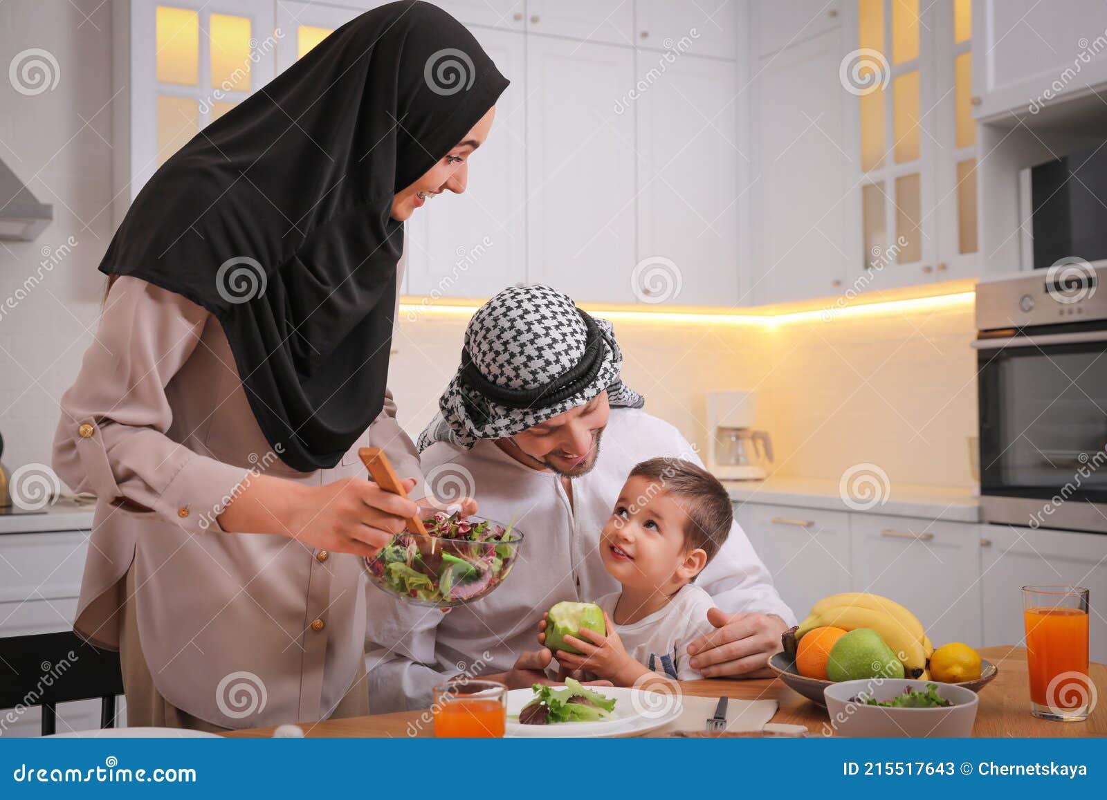 Happy Muslim Family Eating Together in Kitchen Stock Image - Image of ...