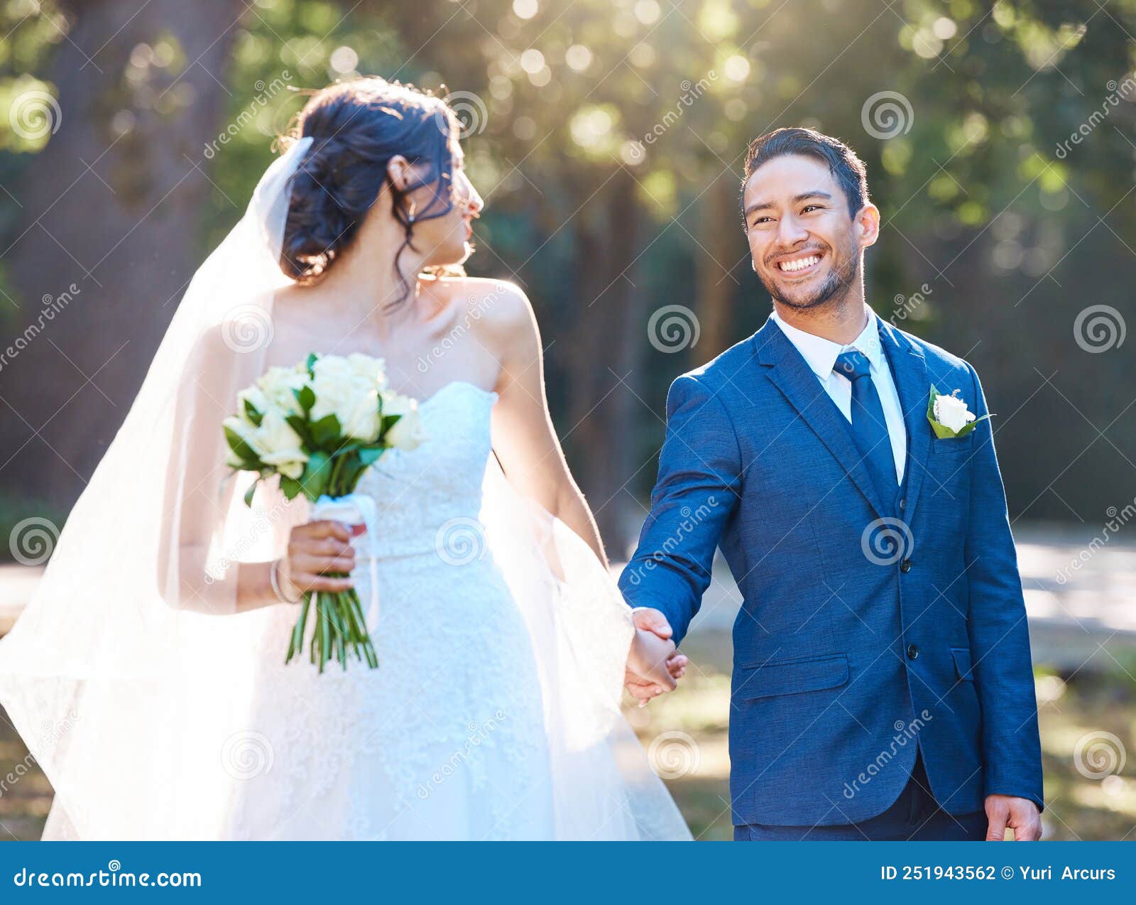 Happy Newlywed Couple Looking at Each Other while Holding Hands and ... Happy Newlywed Couple Looking at Each Other while Holding Hands and ...