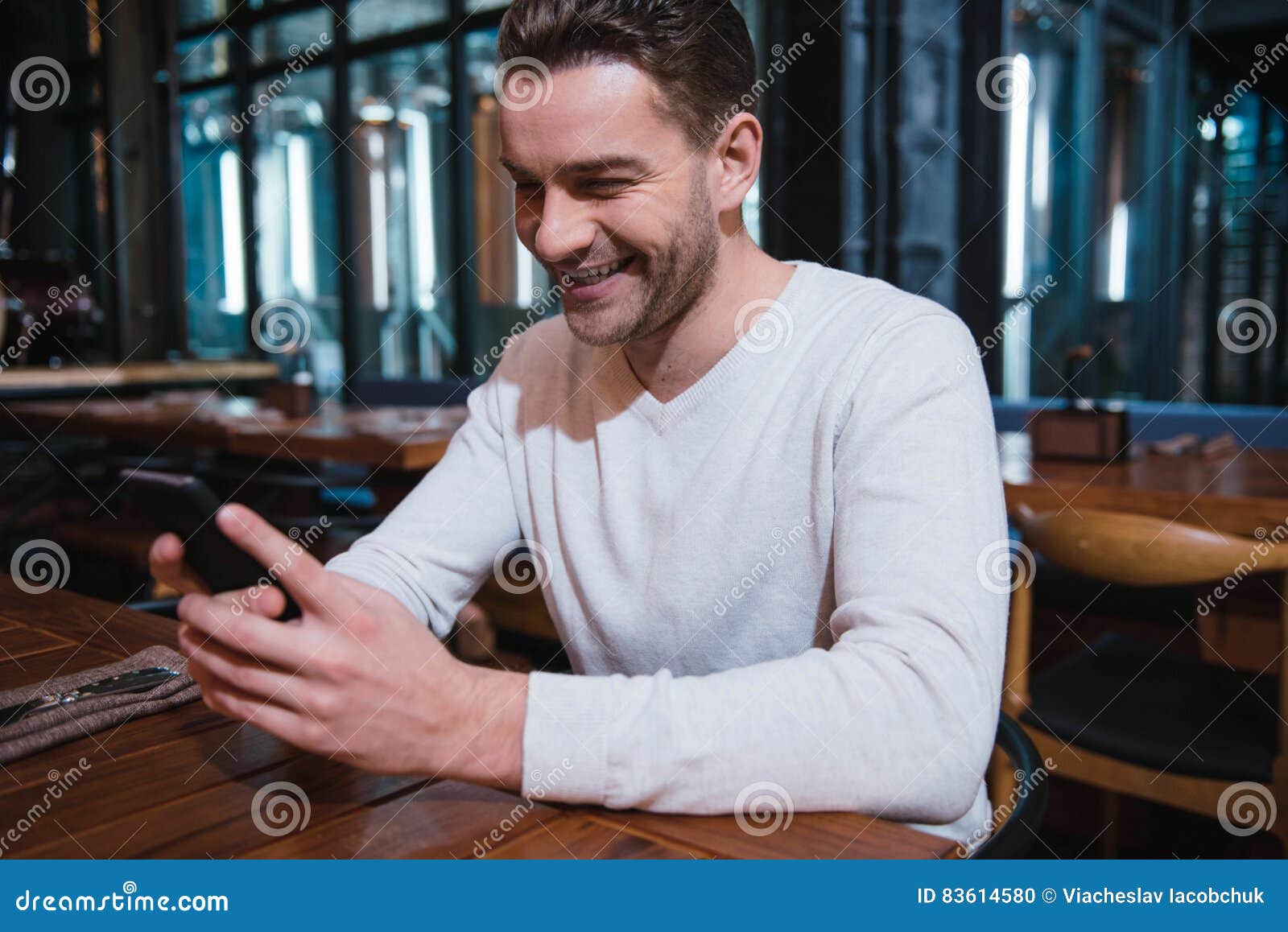 Happy Nice Man Looking at the Screen of His Smartphone Stock Photo ...