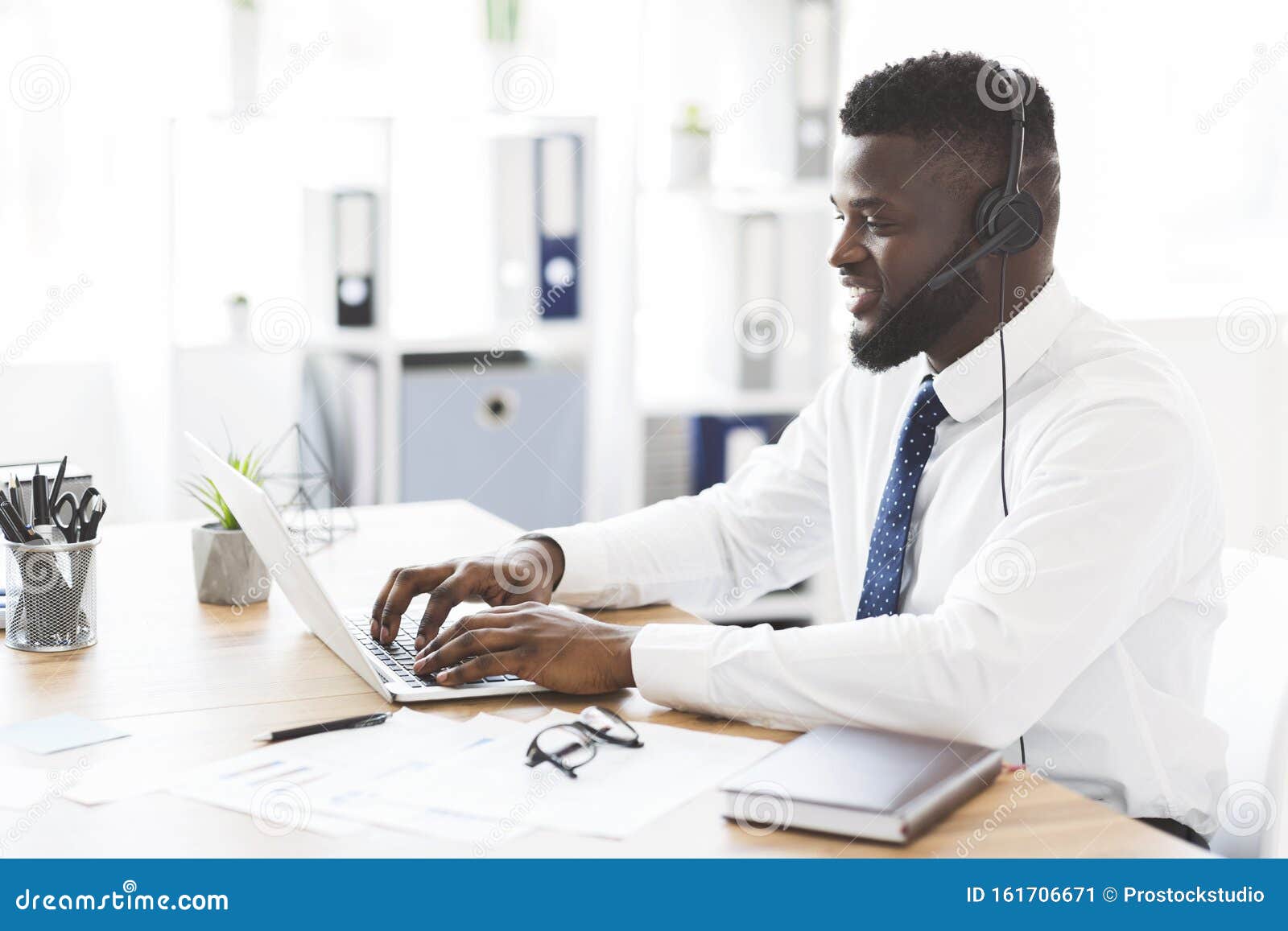 Happy Office Worker Helping Clients, Using Laptop Stock Image - Image ...