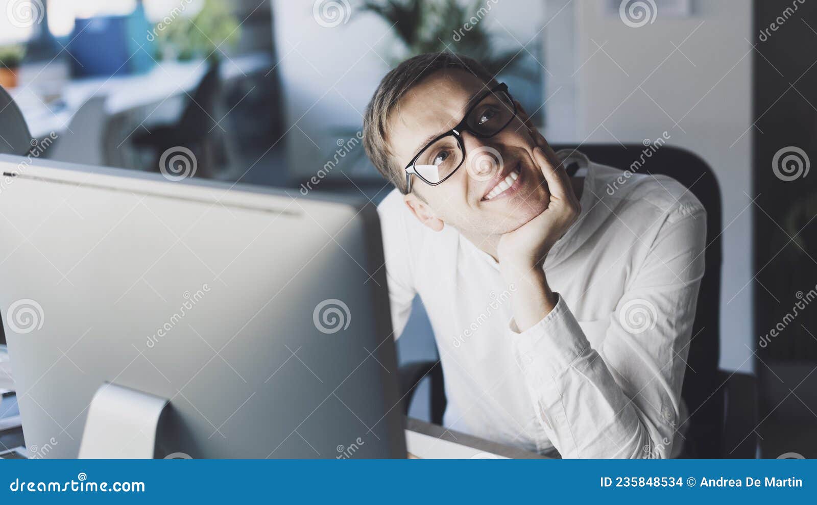Happy Office Worker Sitting at Desk and Looking Away Stock Photo ...