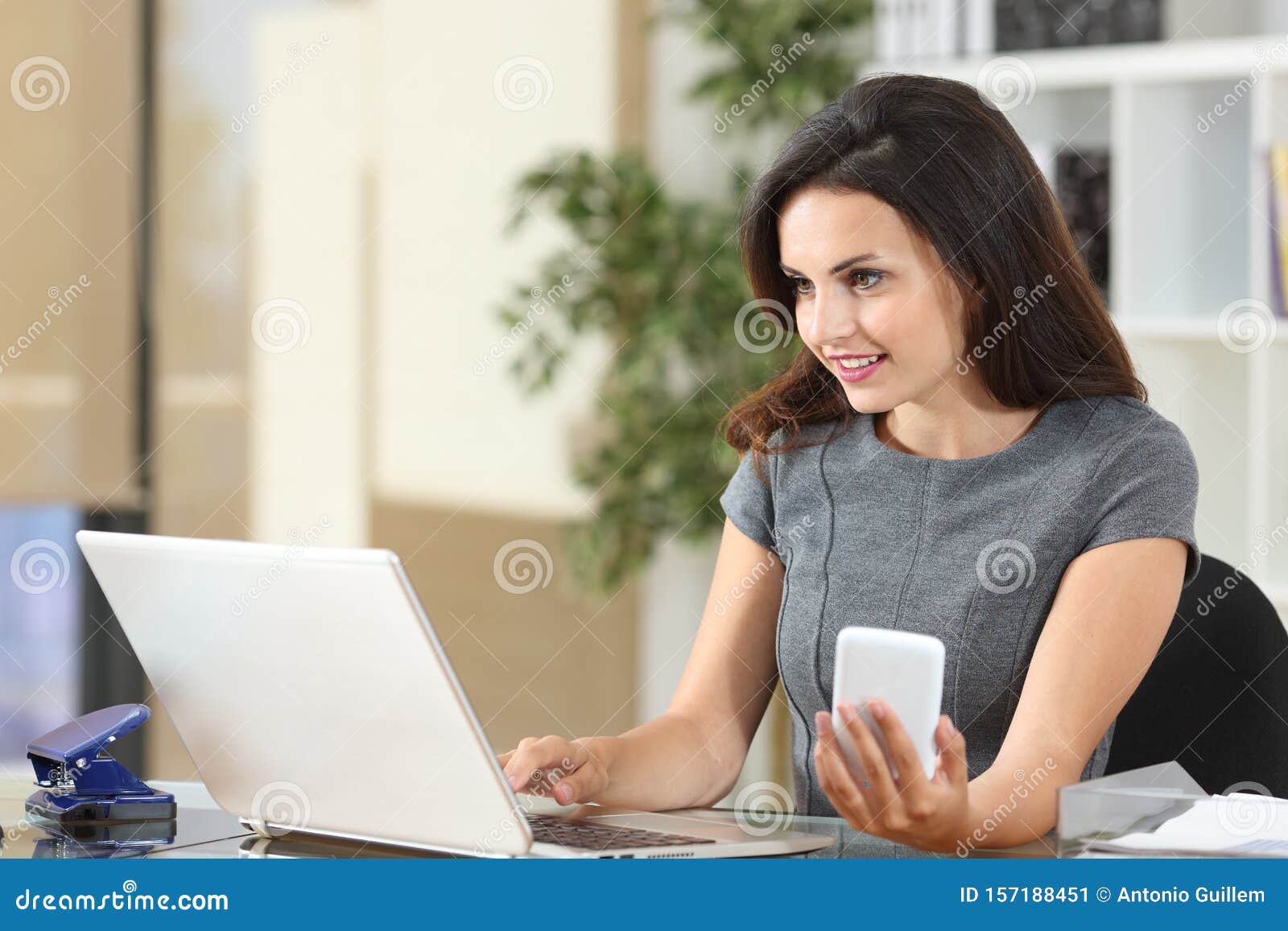 Happy Office Worker Working on Line Using Phone and Laptop Stock Image ...