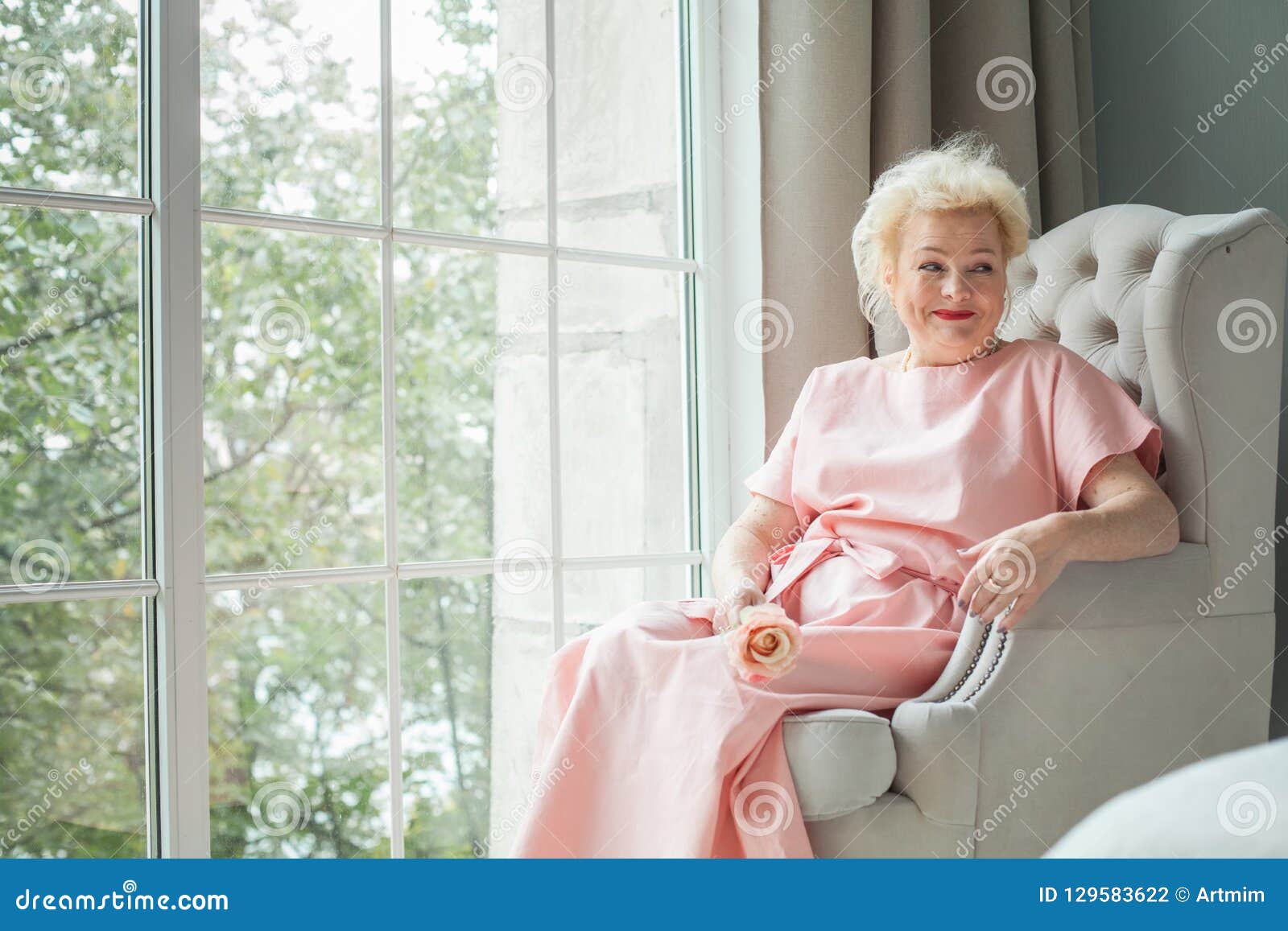 Happy older woman at home stock photo. Image of portrait - 129583622