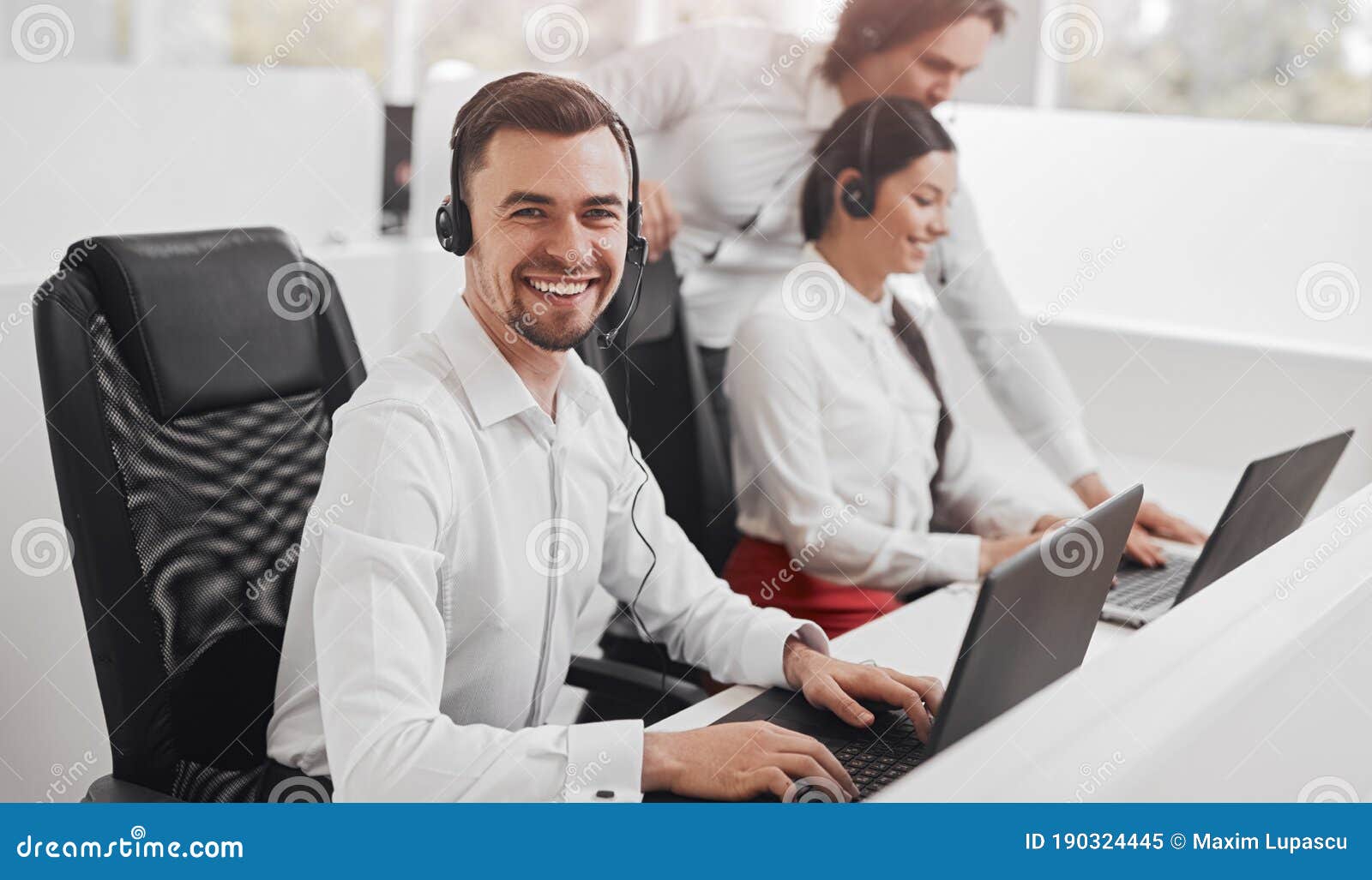 Happy Operator Using Laptop Near Team Stock Image - Image of indoors ...