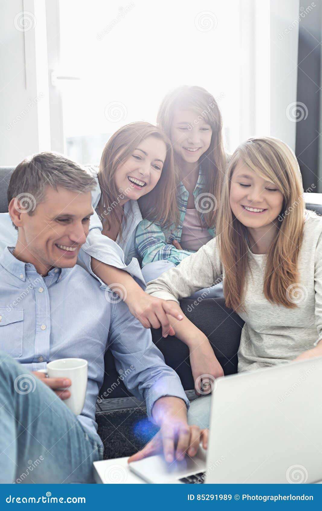 Happy Parents with Daughters Using Laptop in Living Room Stock Image ...