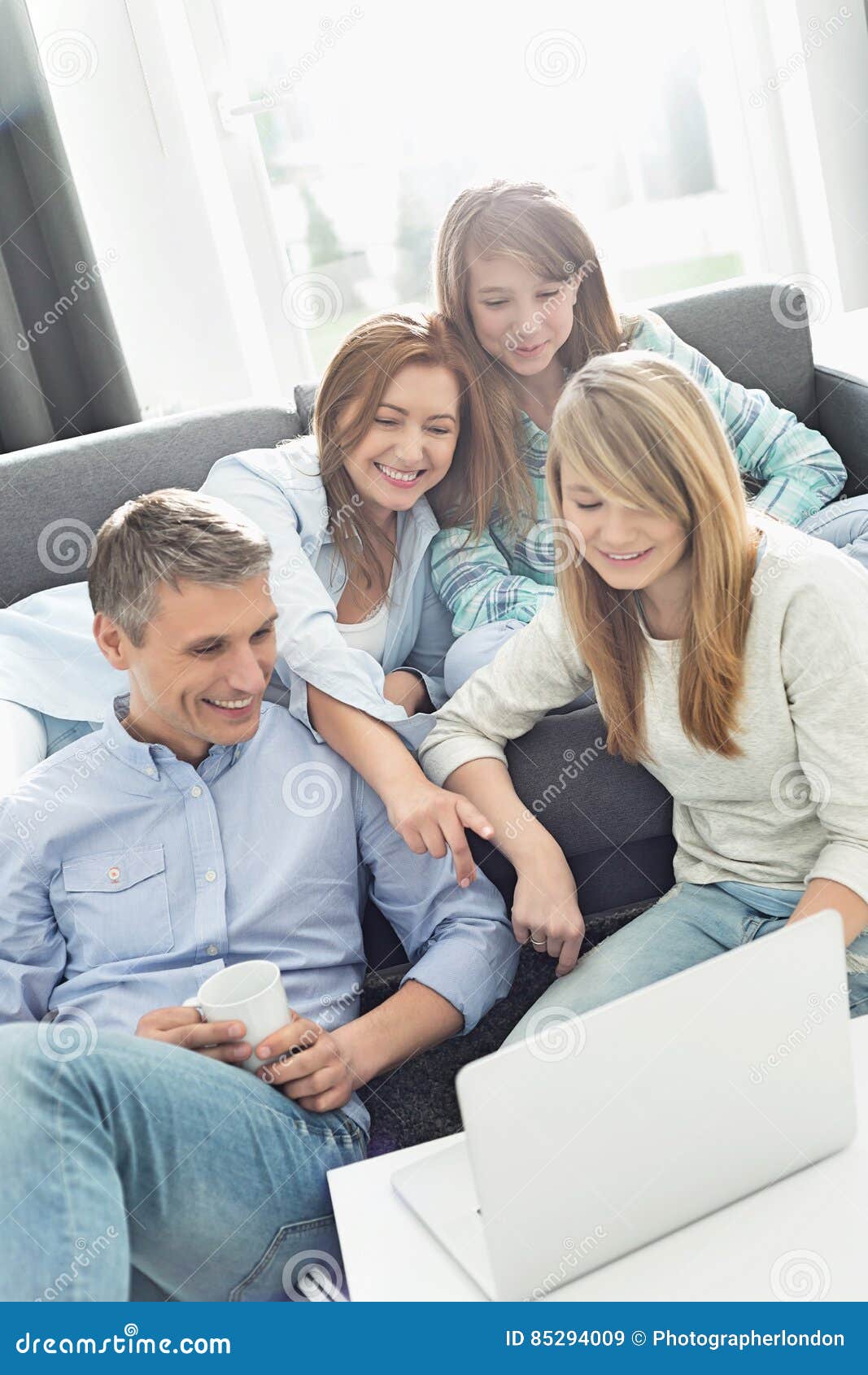 Happy Parents with Daughters Using Laptop in Living Room Stock Image ...
