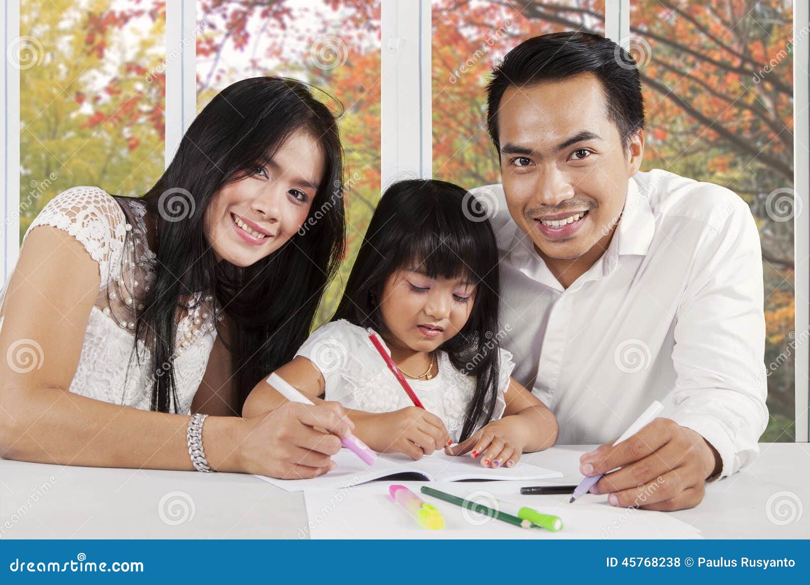 Happy Parents Help Their Child Studying Stock Photo - Image of book ...